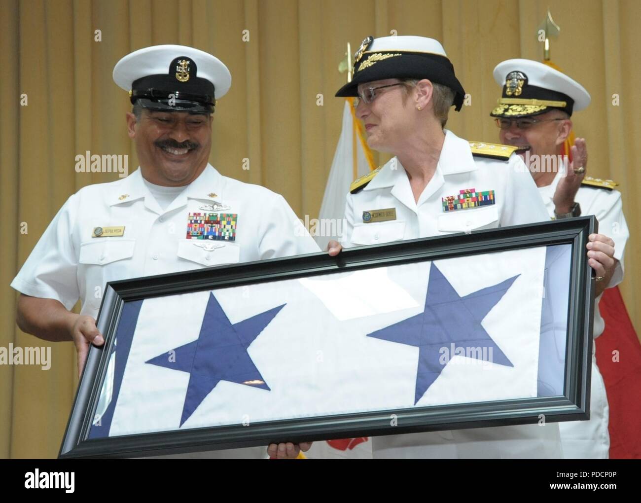 Rear Adm. Rebecca McCormick-Boyle is presented her personal flag by ...