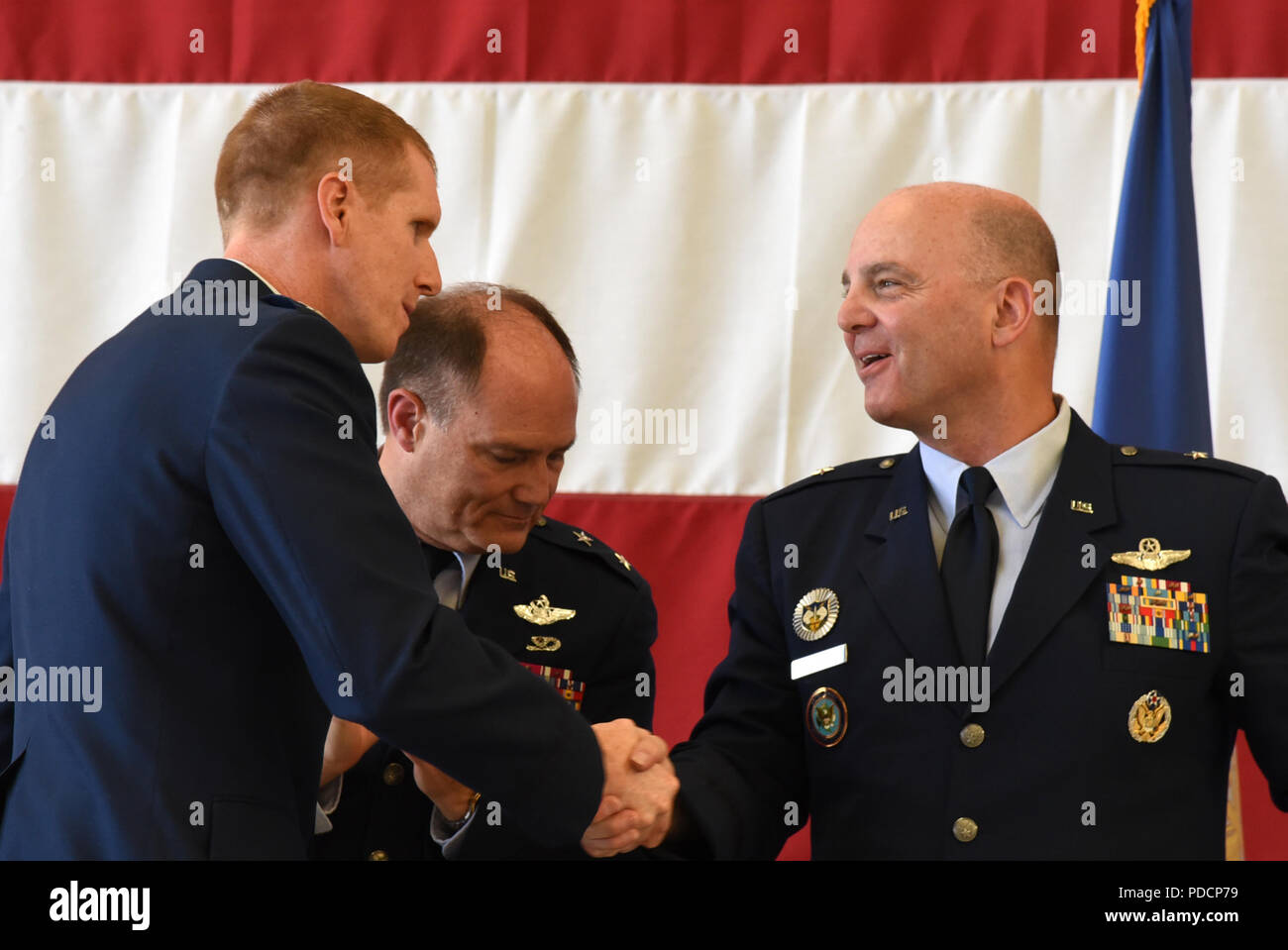 Oregon Air National Guard Col. Adam Sitler (left) shakes hands with ...