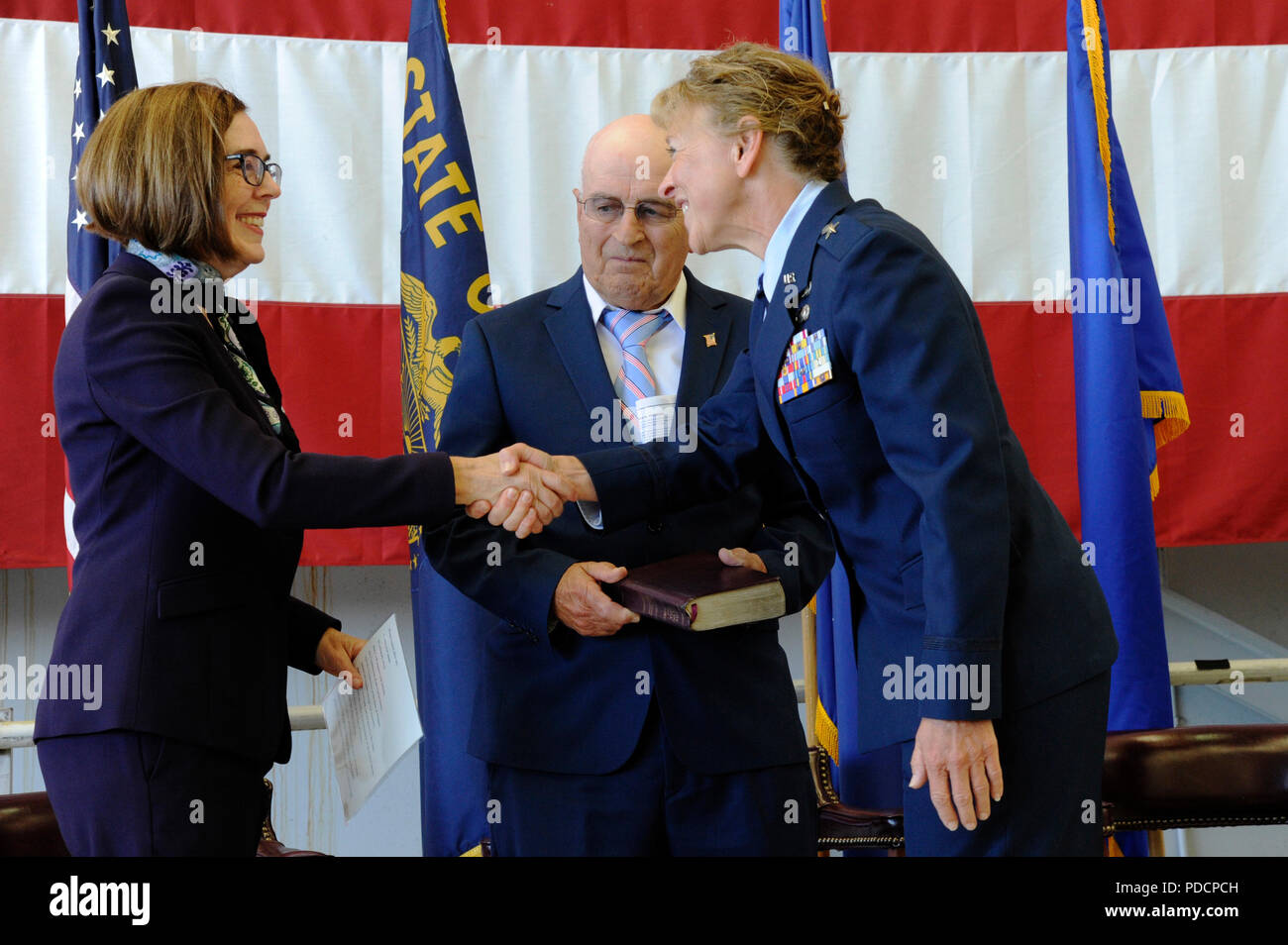 Oregon Air National Guard Col. Donna Prigmore (center) shakes hands ...