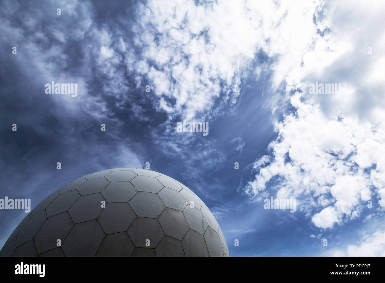 White radar ball under dramatic cloudy sky. Viewpoint Pico Do Arieiro ...
