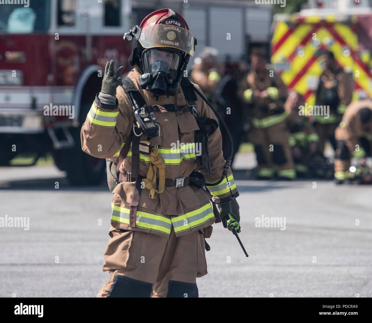 An 18th Civil Engineer Squadron fire fighter gives hand signals to ...
