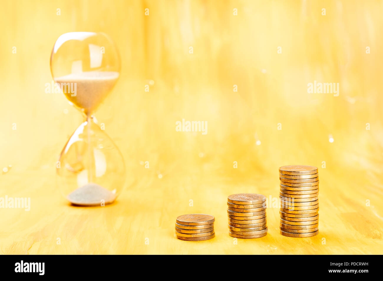 Money growth over time. A heap of coins on an abstract golden texture ...