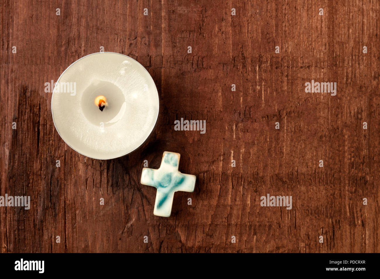 An overhead photo of a simple cross, teal and white, with a little ...