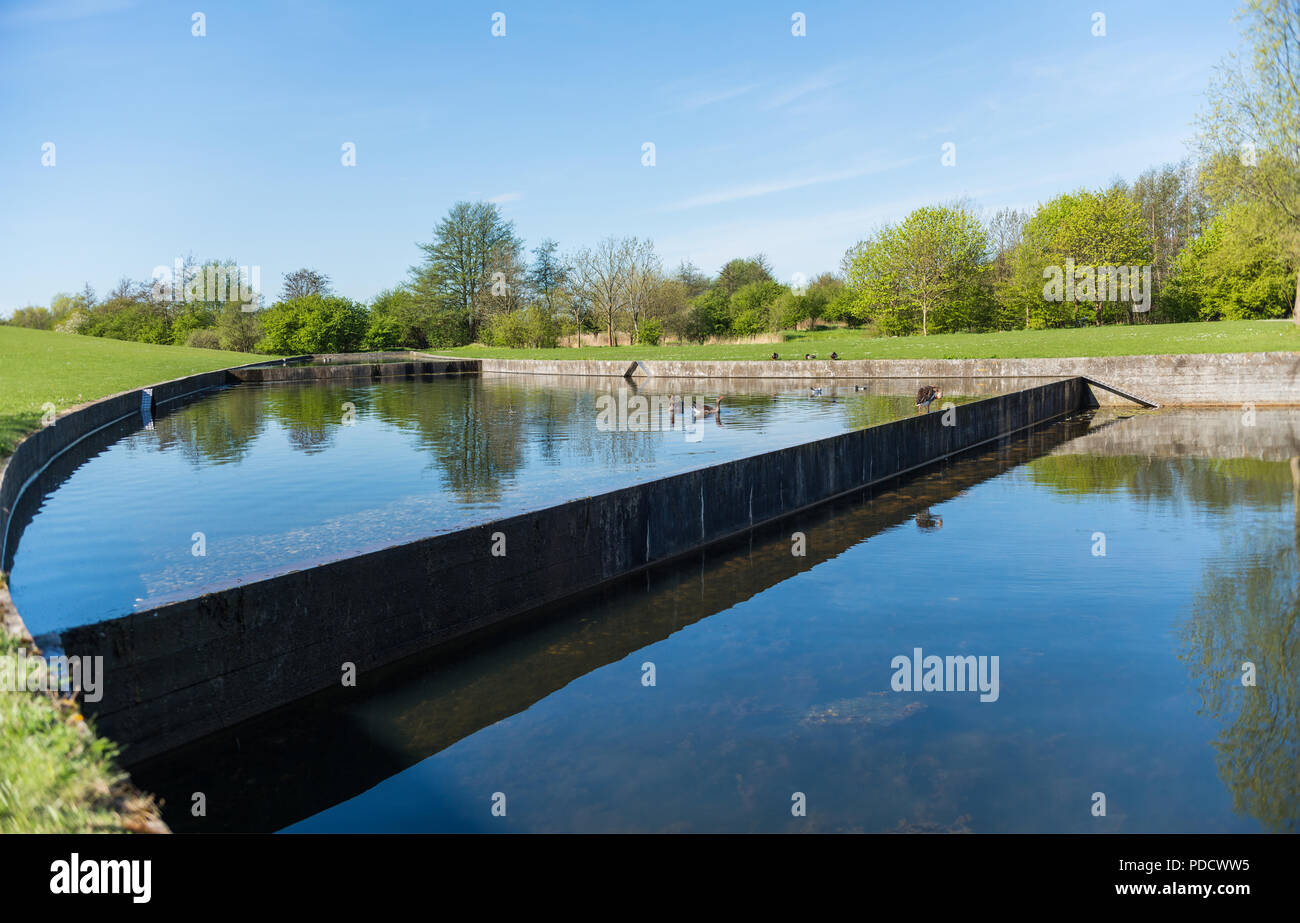 scenic view of city river and ducks on green lawn in copenhagen ...