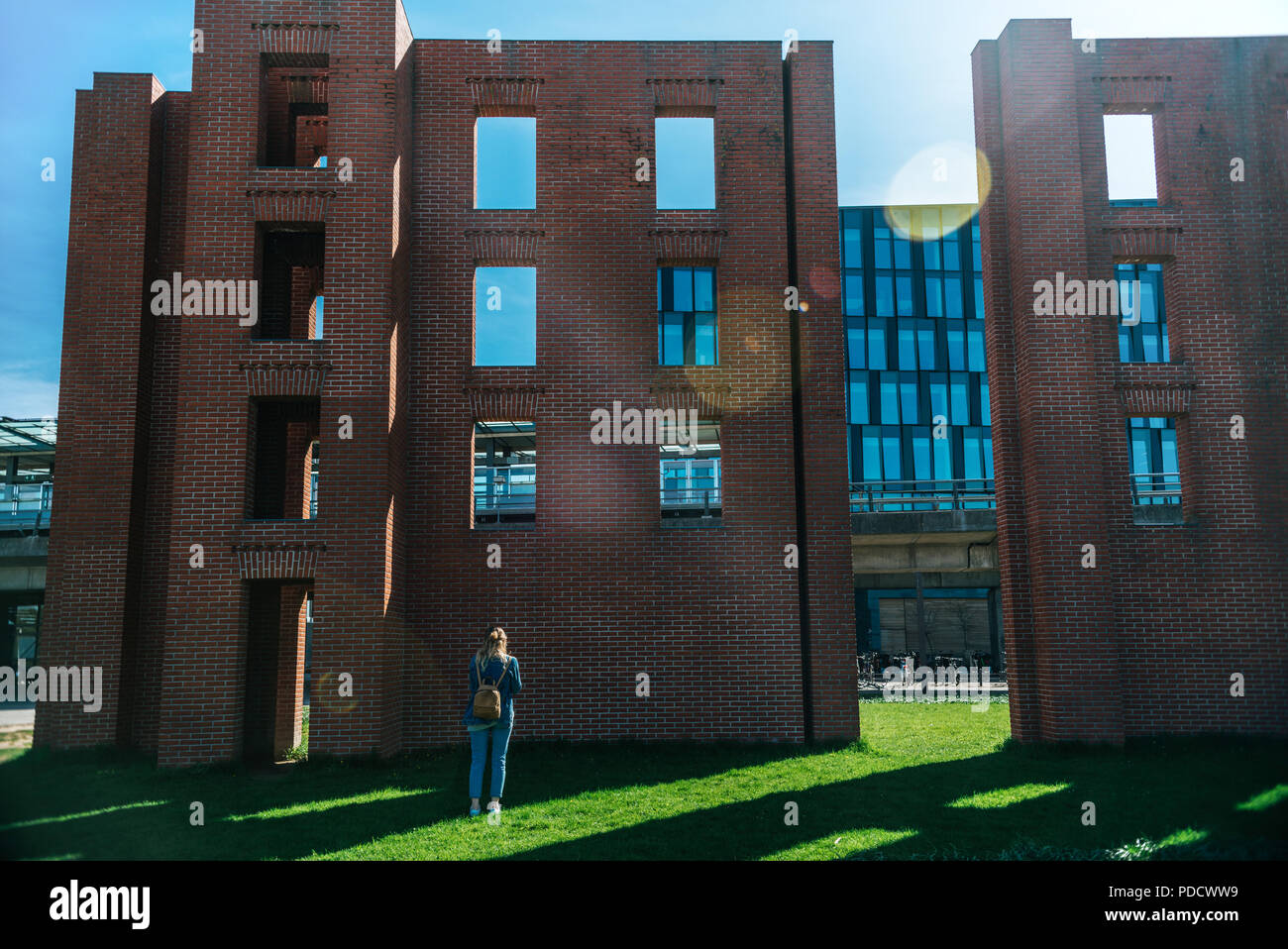 back view of woman with backpack and architecture of copenhagen city ...