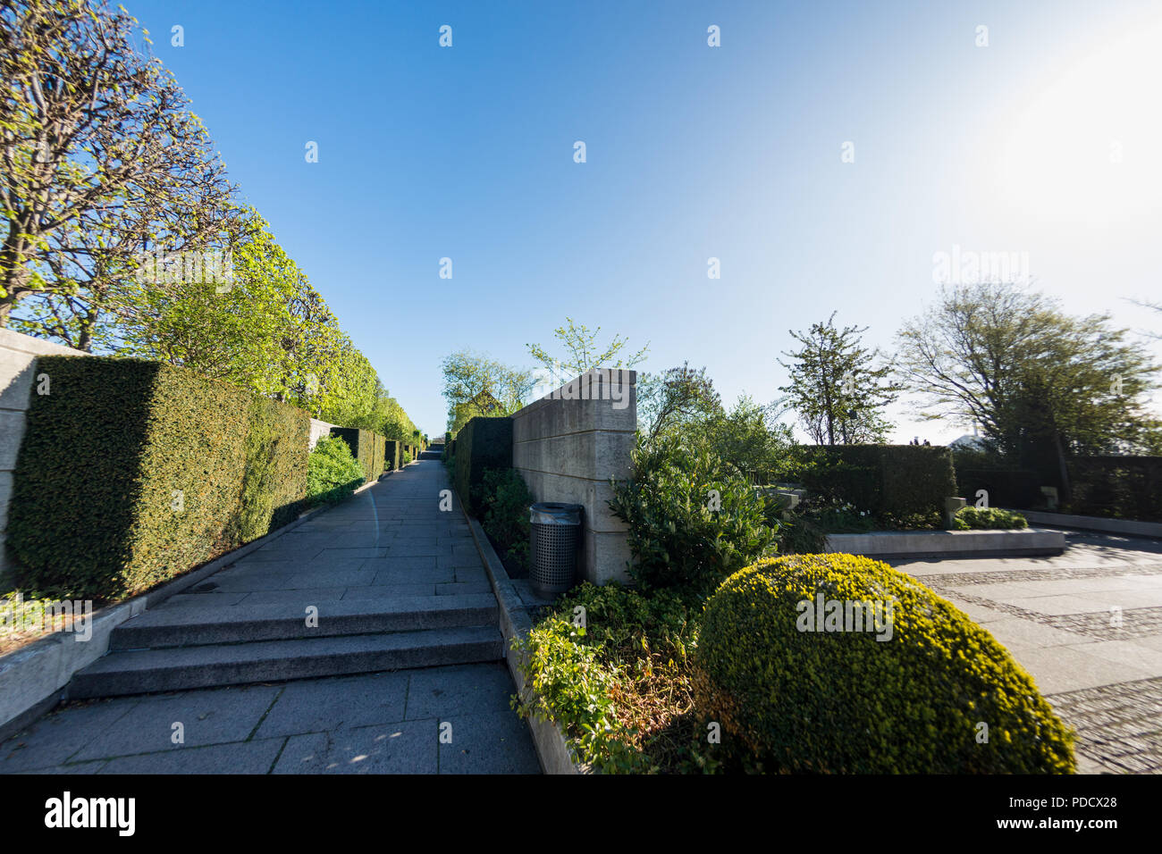 cozy park with green bushes and walkway at sunny day, copenhagen ...