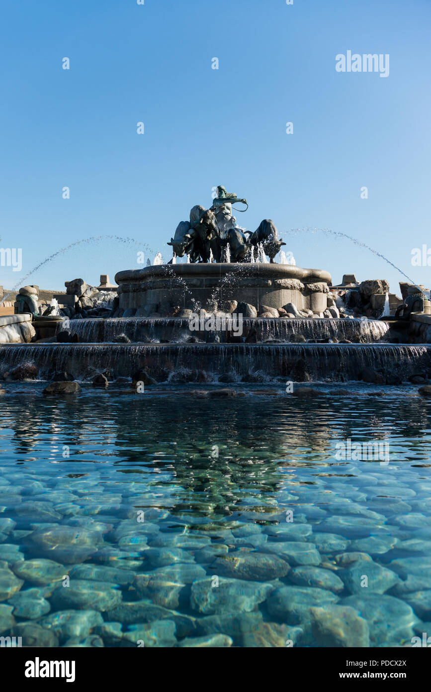 low angle view of famous Gefion Fountain against blue sky in copenhagen ...