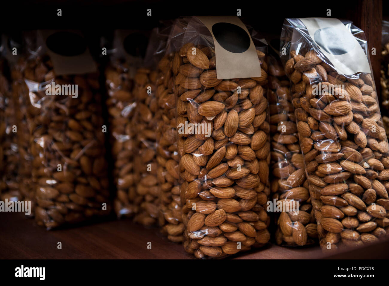 close up view of almonds in plastic packaging Stock Photo - Alamy
