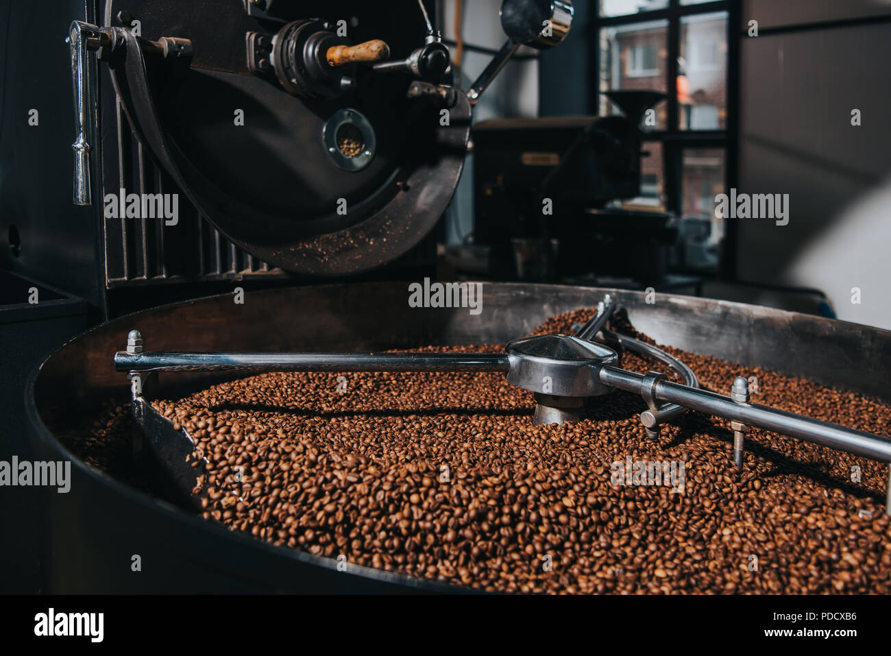 Interior of coffee production workshop with working coffee roasting ...