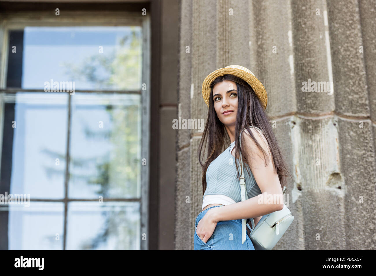 side view of young beautiful woman in straw hat on street Stock Photo ...