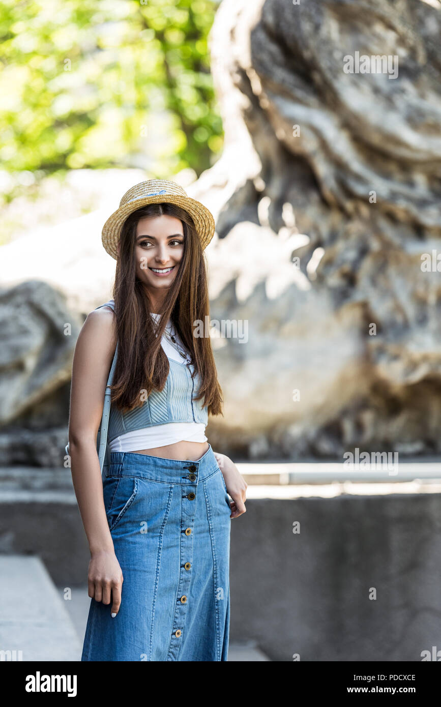 portrait of beautiful smiling woman with long hair in straw hat on ...