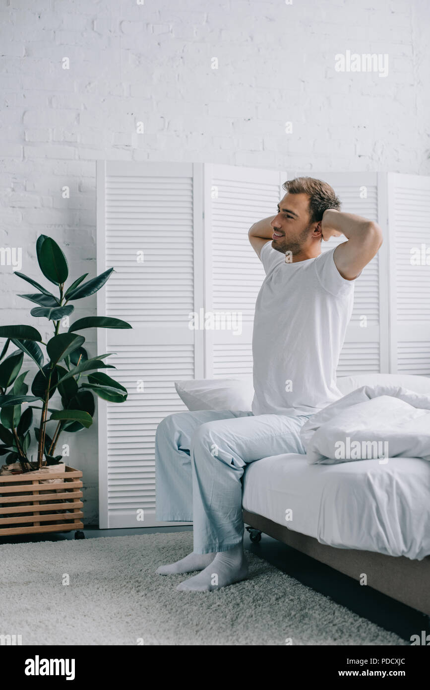 Man sitting in bed stretching hi-res stock photography and images - Alamy