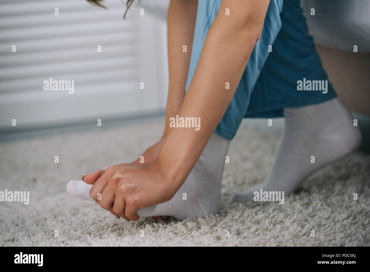 cropped shot of woman having foot pain in bedroom Stock Photo - Alamy