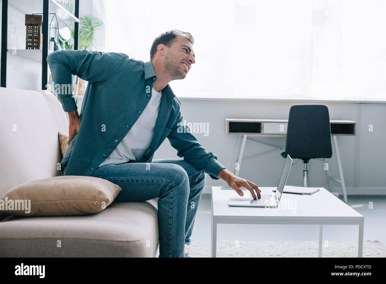 Casual man back pain using hi-res stock photography and images - Alamy