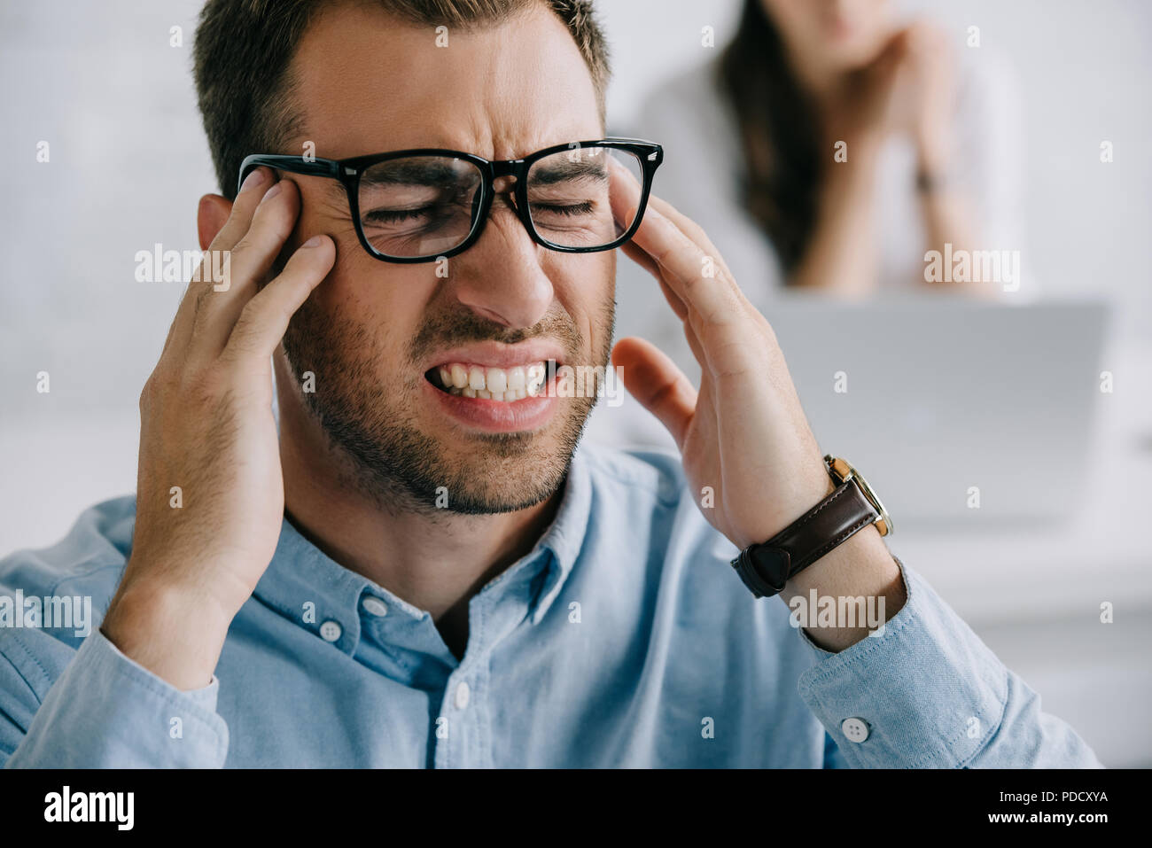 close-up view of young businessman in eyeglasses suffering from ...
