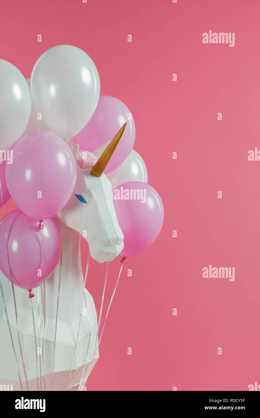 Decorative unicorn among pink and white balloons isolated on pink Stock ...