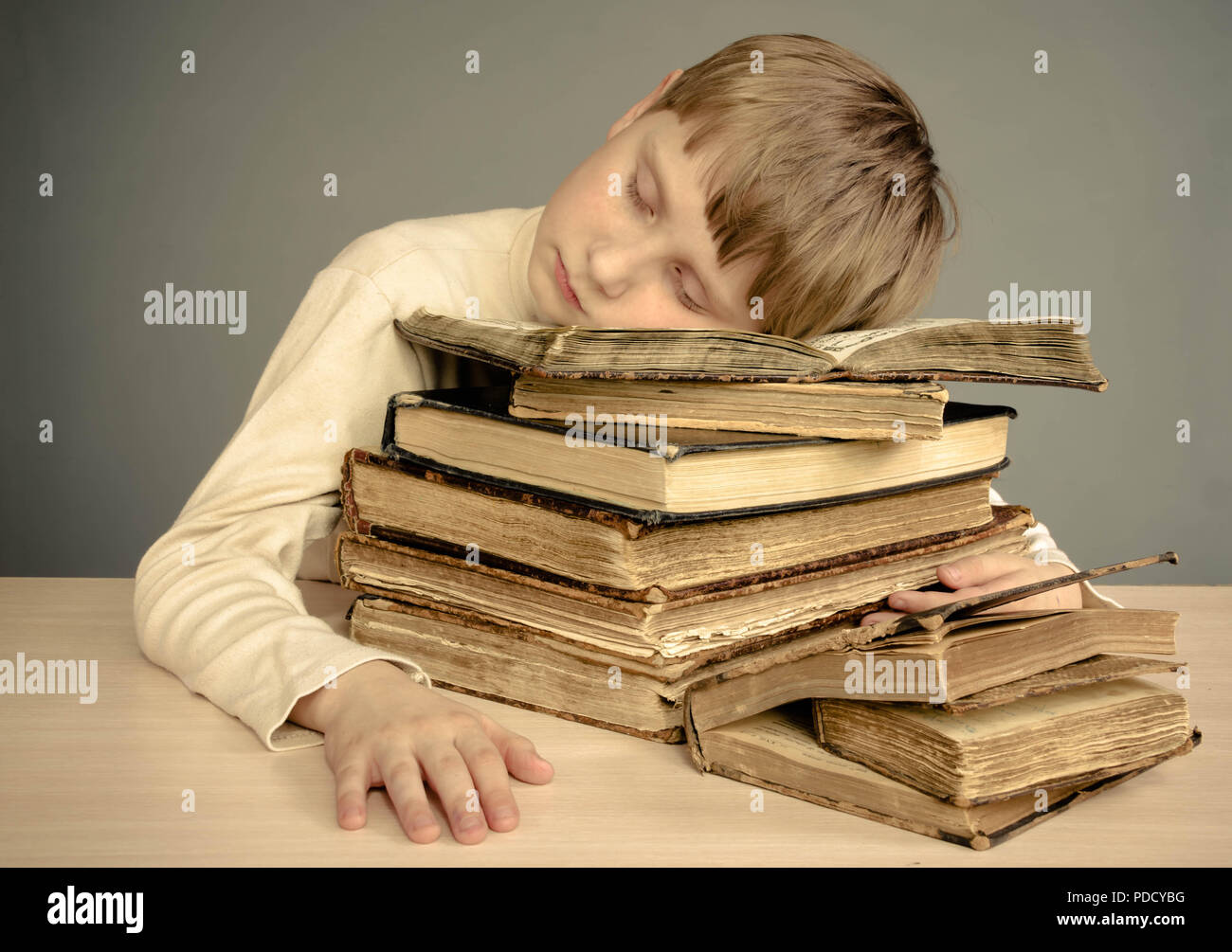A boy is hugging a pile of books - a concept back to school Stock Photo ...