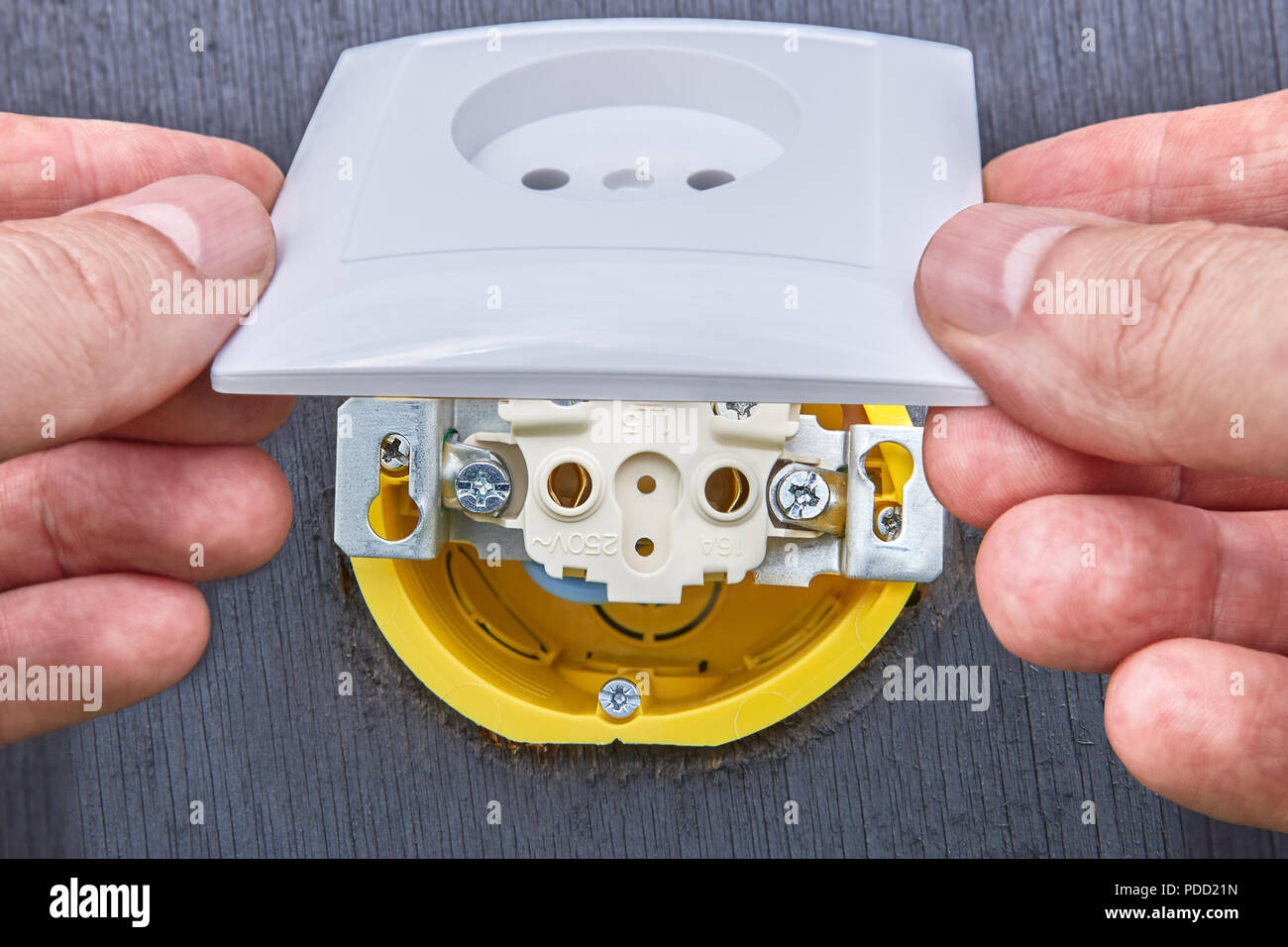 Mounting household power socket in home electrical network, close-up ...
