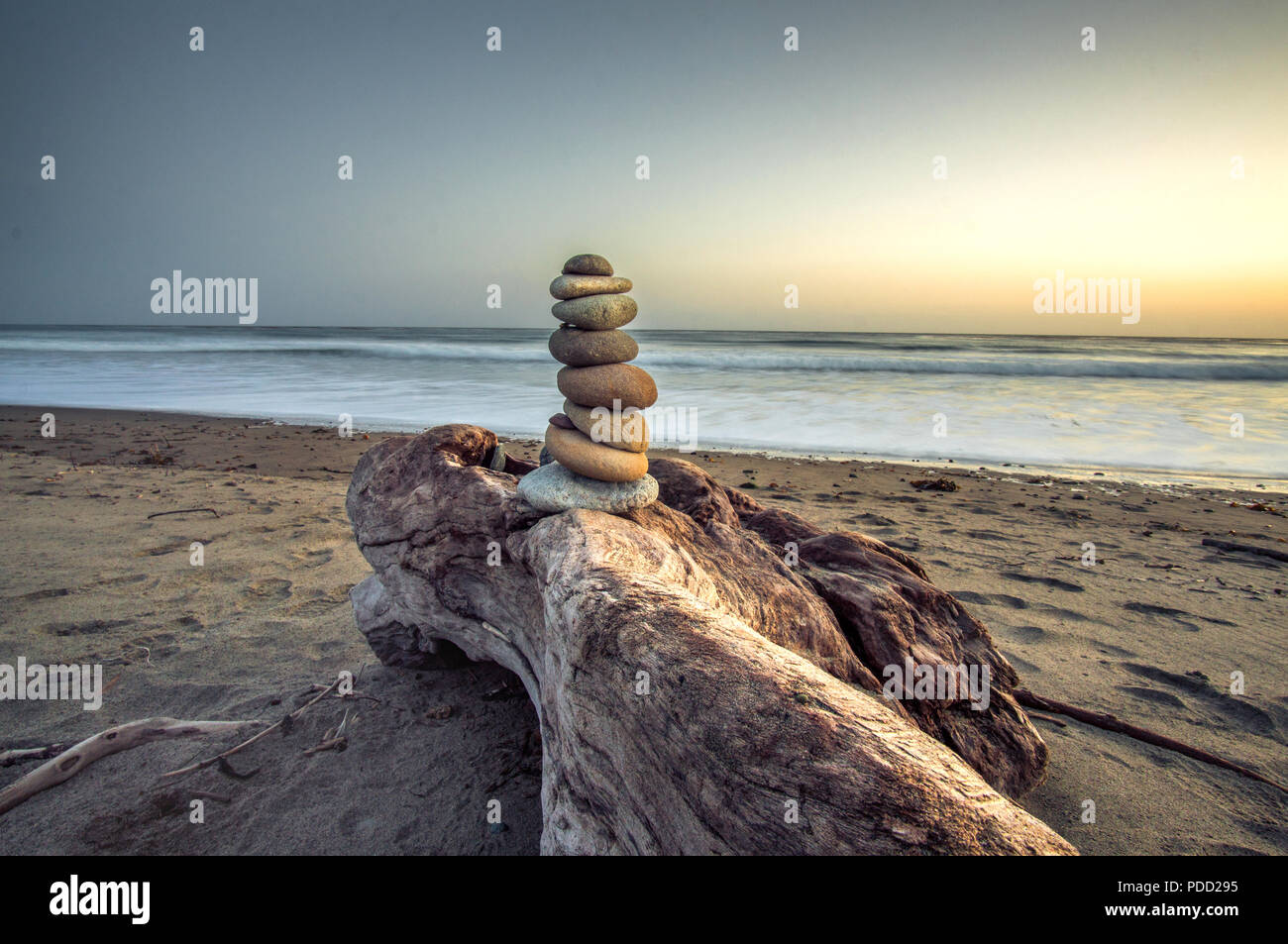 Stacked pebbles and a beautiful sunset on the Californian beach Stock ...