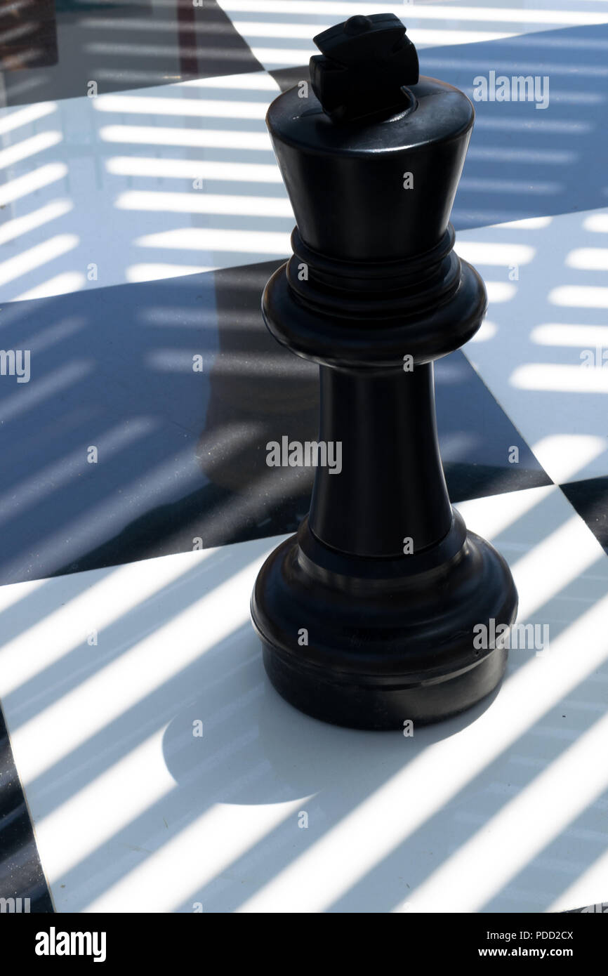 Chess photographed on a chess board, Chess piece king in front of white ...