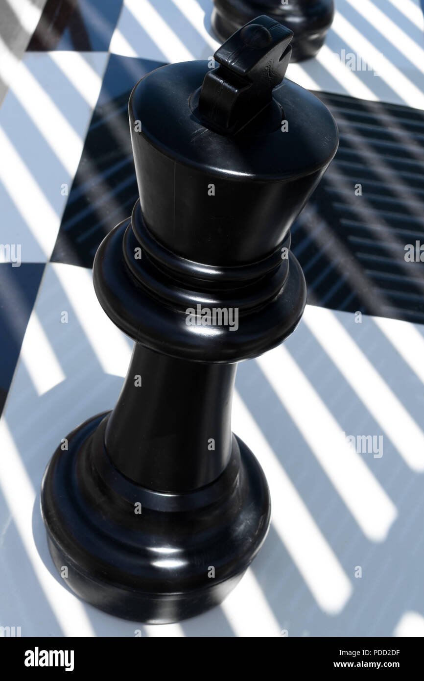 Chess photographed on a chess board, Chess piece king in front of white ...