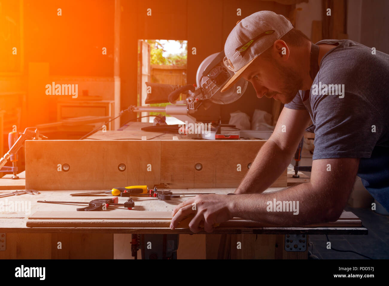 Experienced carpenter in work clothes and small buiness owner working ...