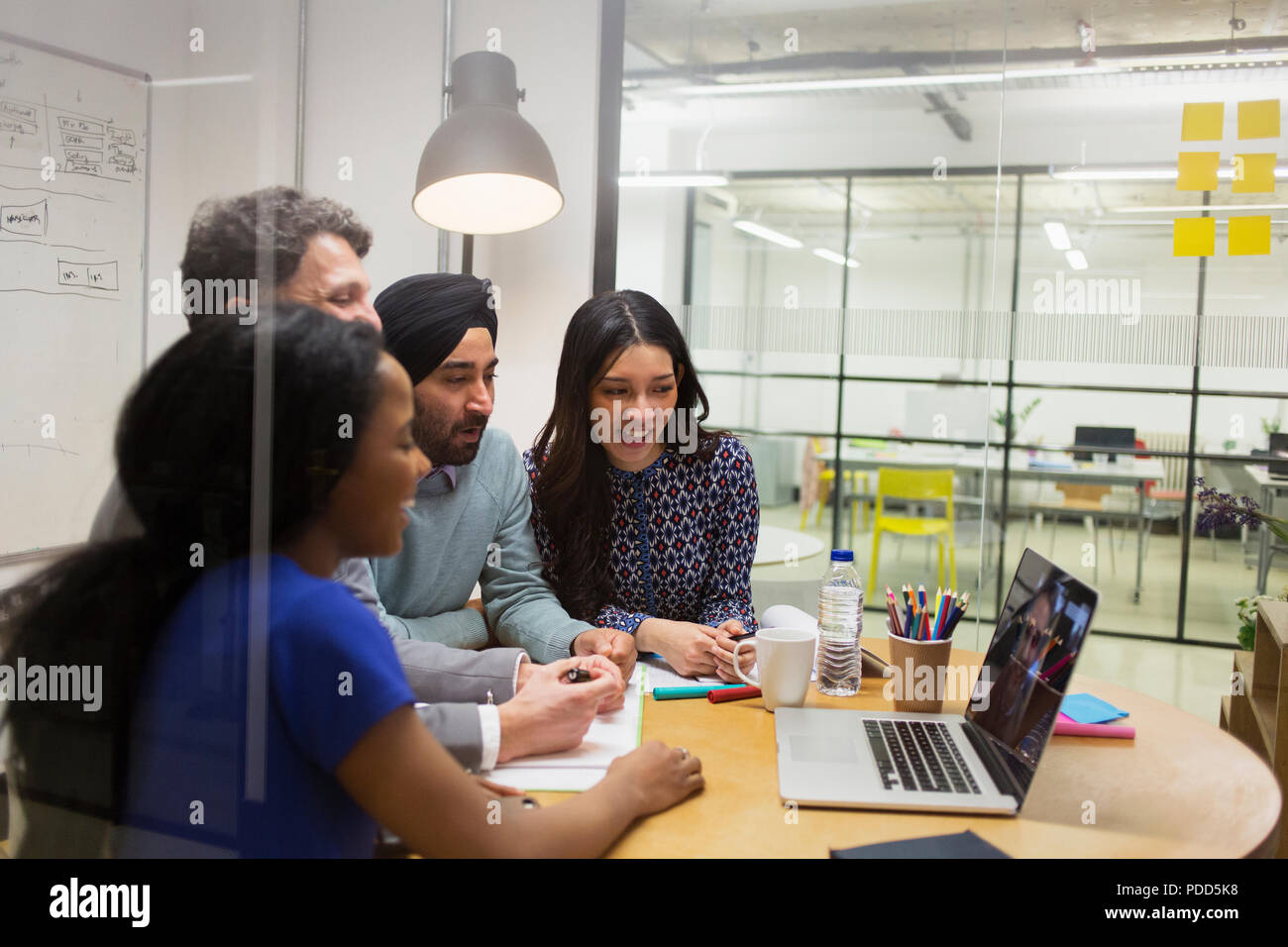 Creative business people video conferencing at laptop in conference ...