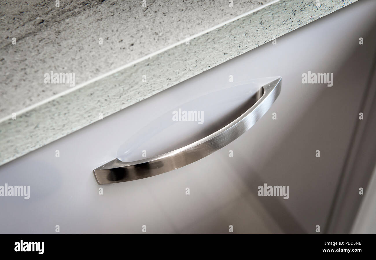 Stainless steel drawer handle in a modern domestic kitchen Stock Photo ...