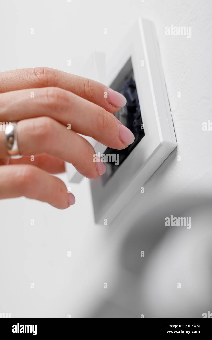the electrician installing the light switch. tool Stock Photo - Alamy