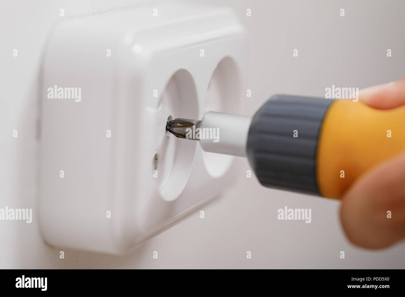 the electrician installing the electrical socket. tool Stock Photo - Alamy