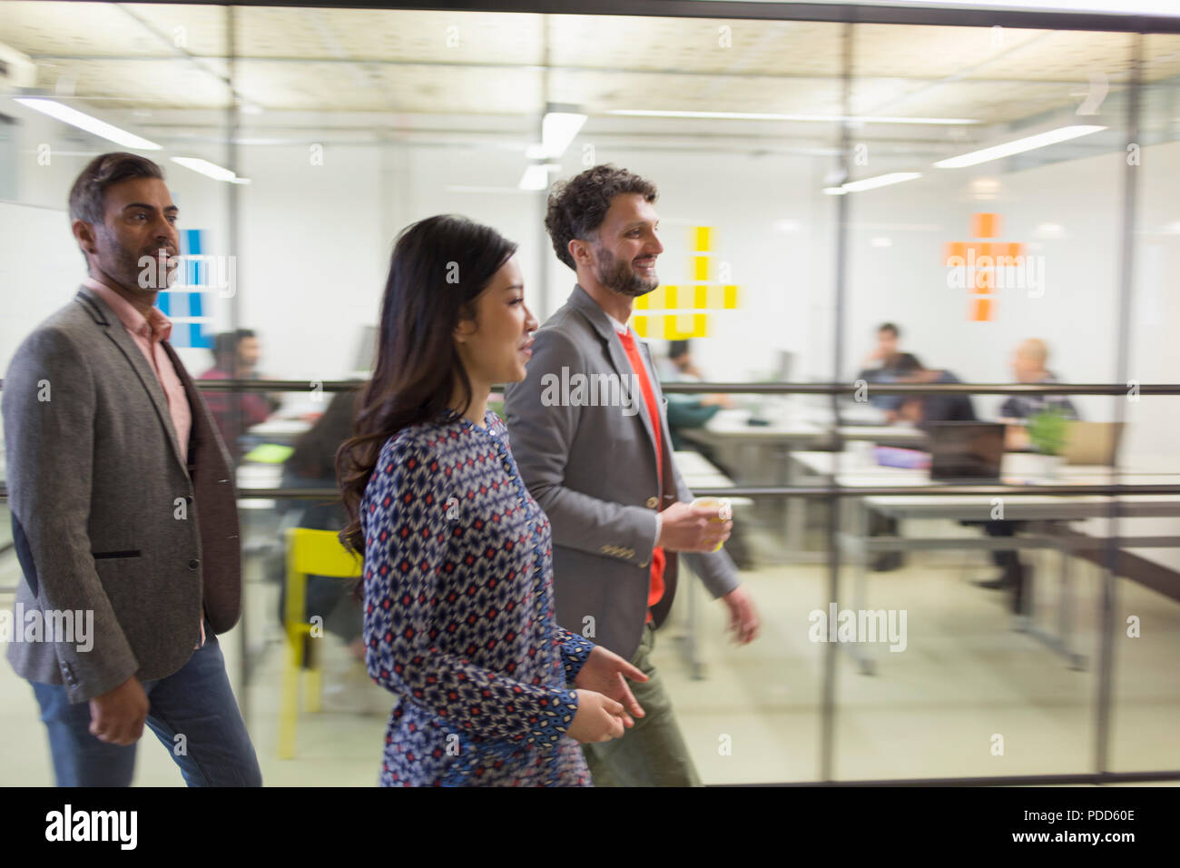 Business people walking in office Stock Photo - Alamy