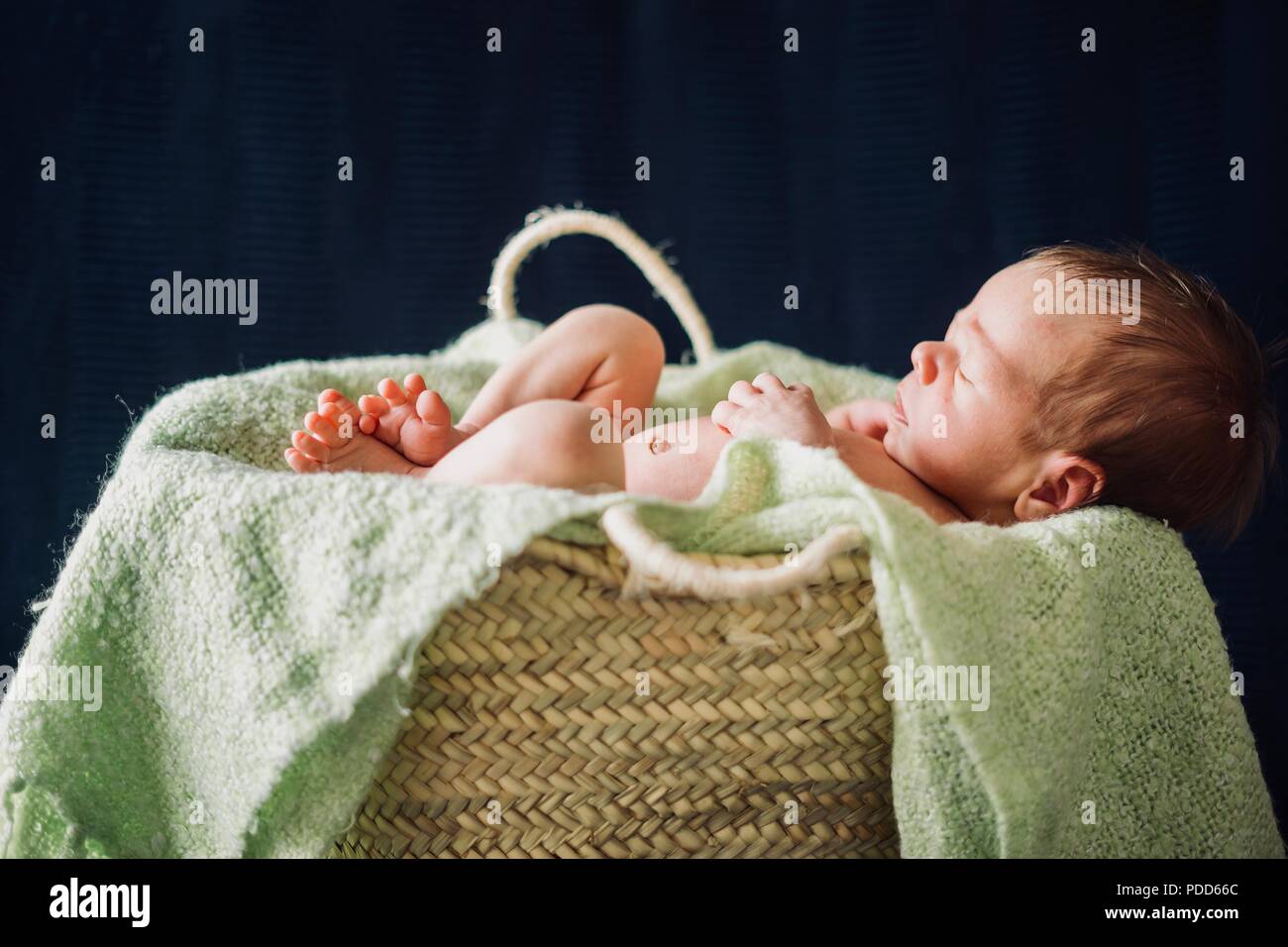 A cute newborn baby boy sleeping in the basket Stock Photo - Alamy