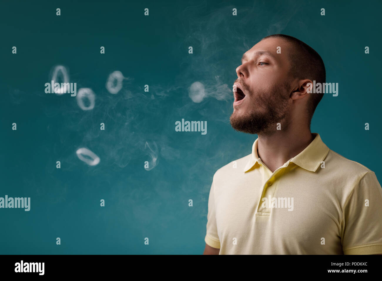 vaping man launches ring of the smoke Stock Photo - Alamy