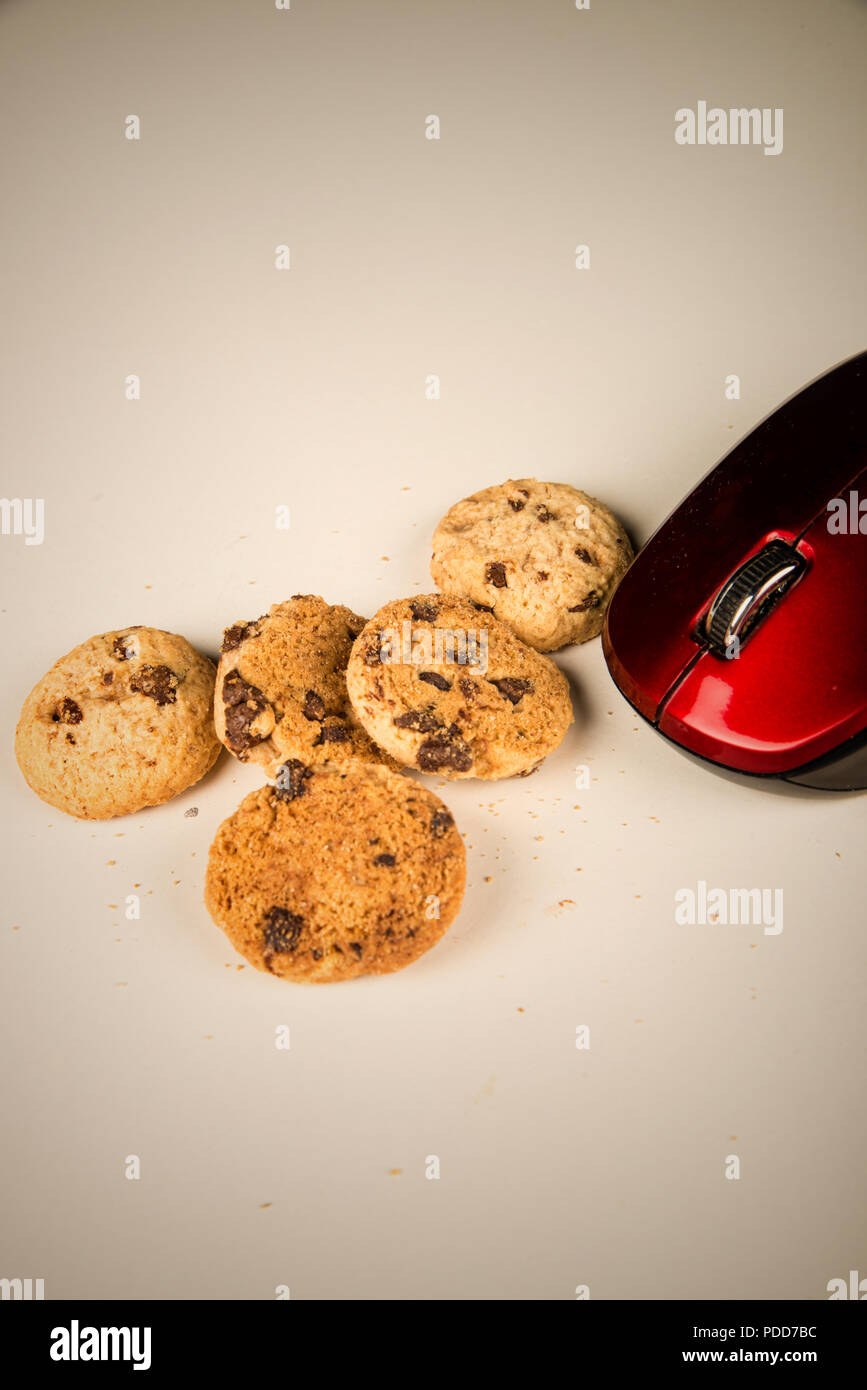 Mouse eating cookies, a funny technology concept Stock Photo - Alamy