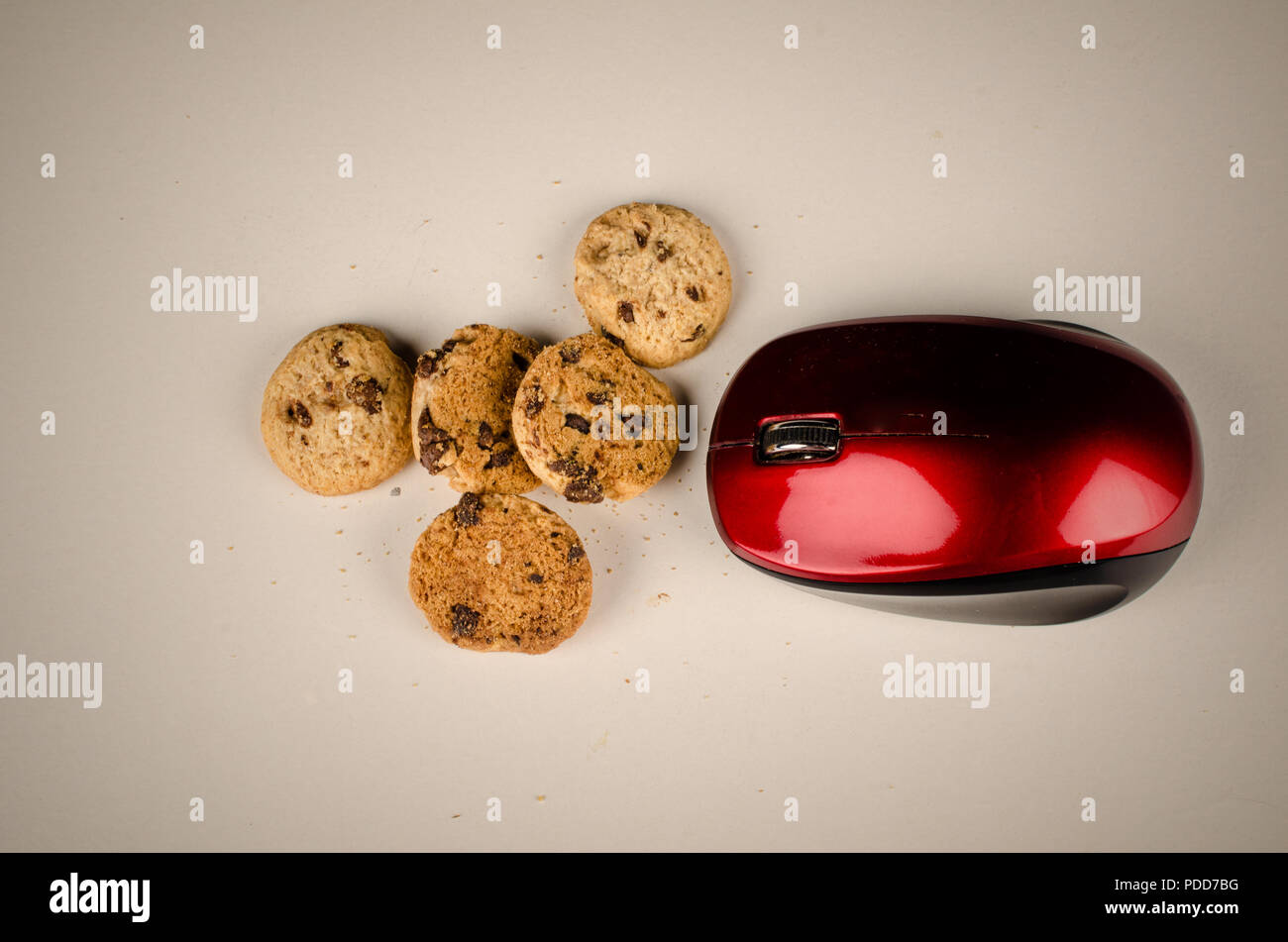 Mouse eating cookies, a funny technology concept Stock Photo - Alamy