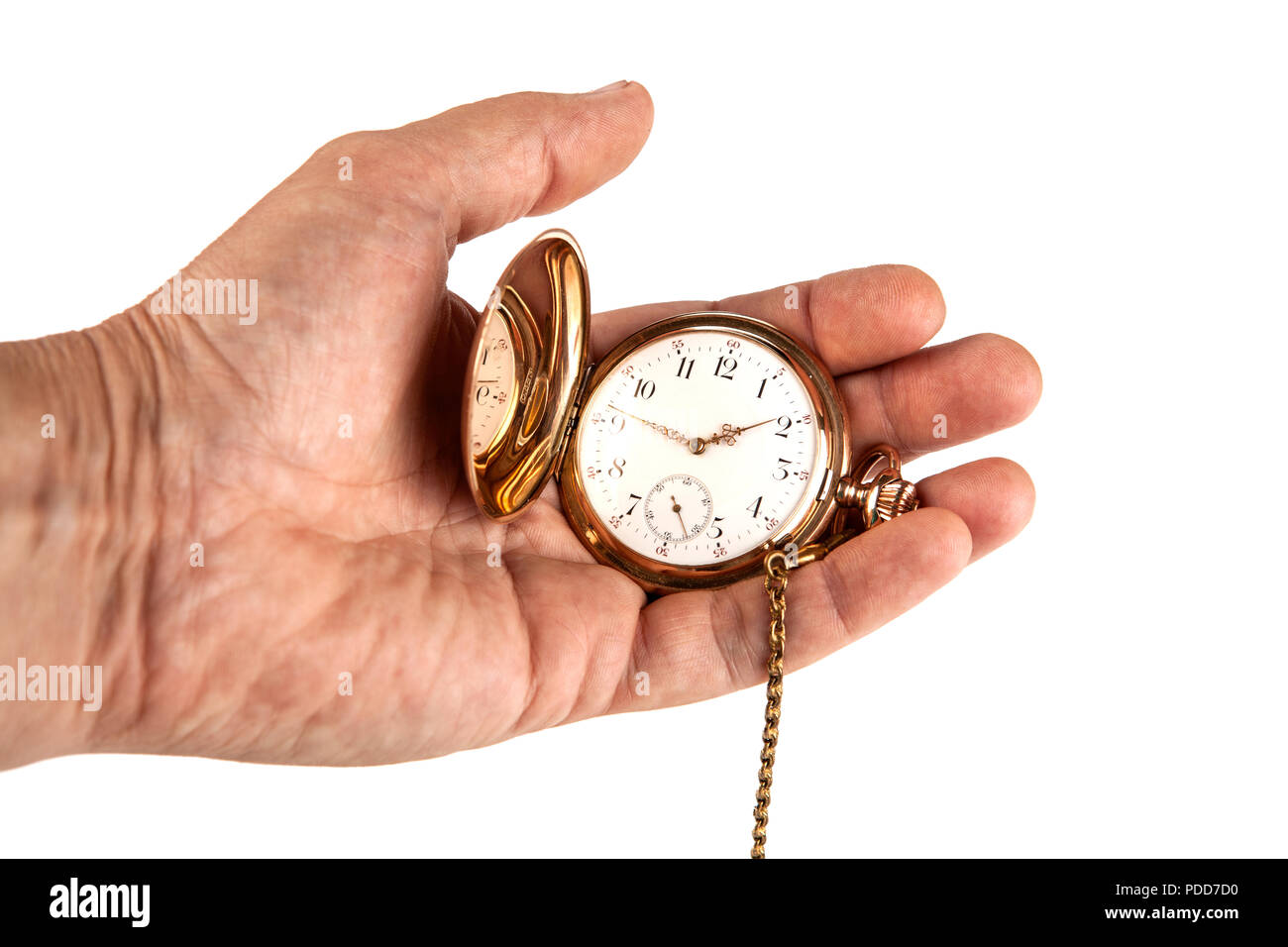 man's hand holds a vintage gold pocket watch on a white backgroundclose ...