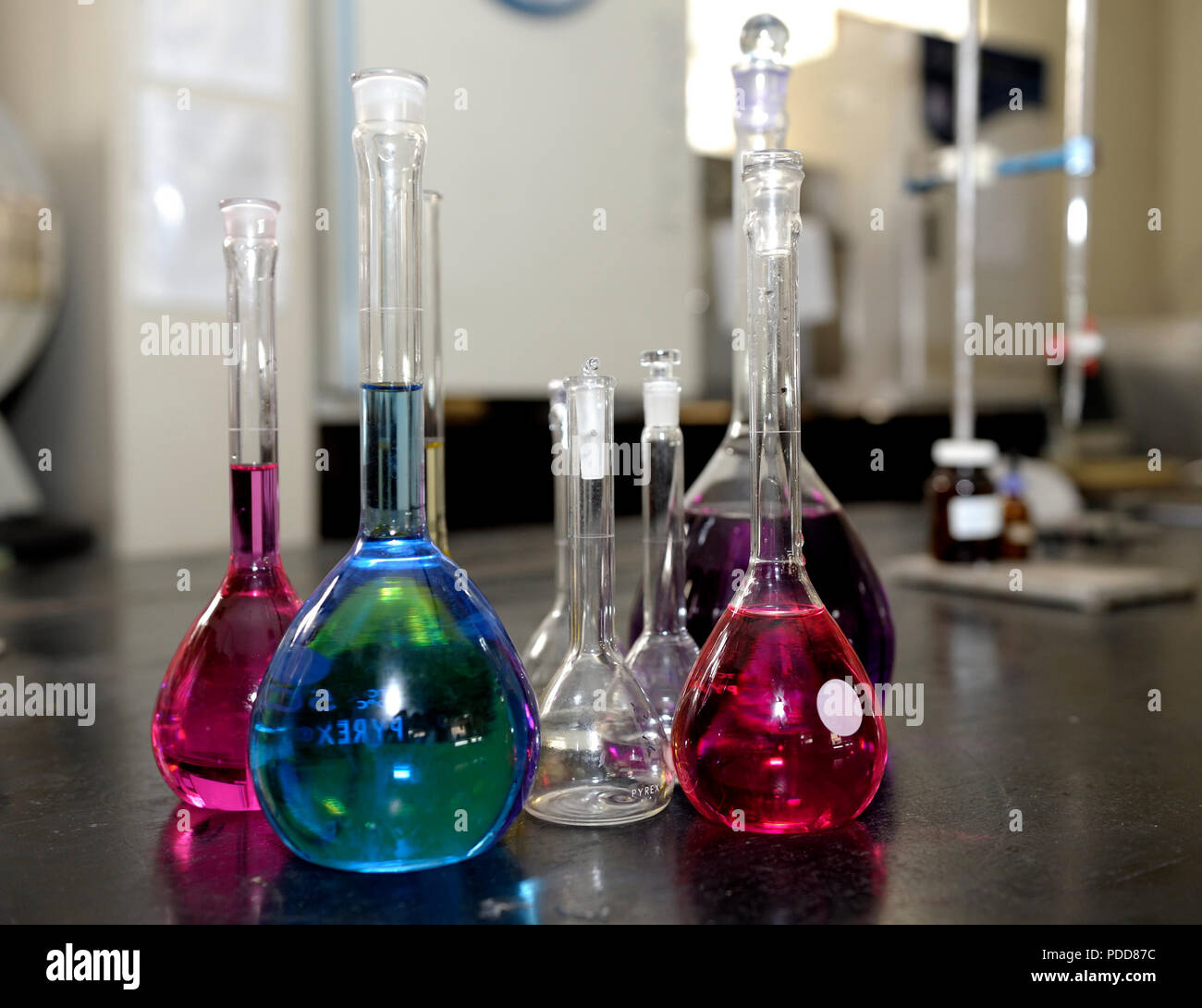 Laboratory glassware containing colorful chemical liquid, lab research ...