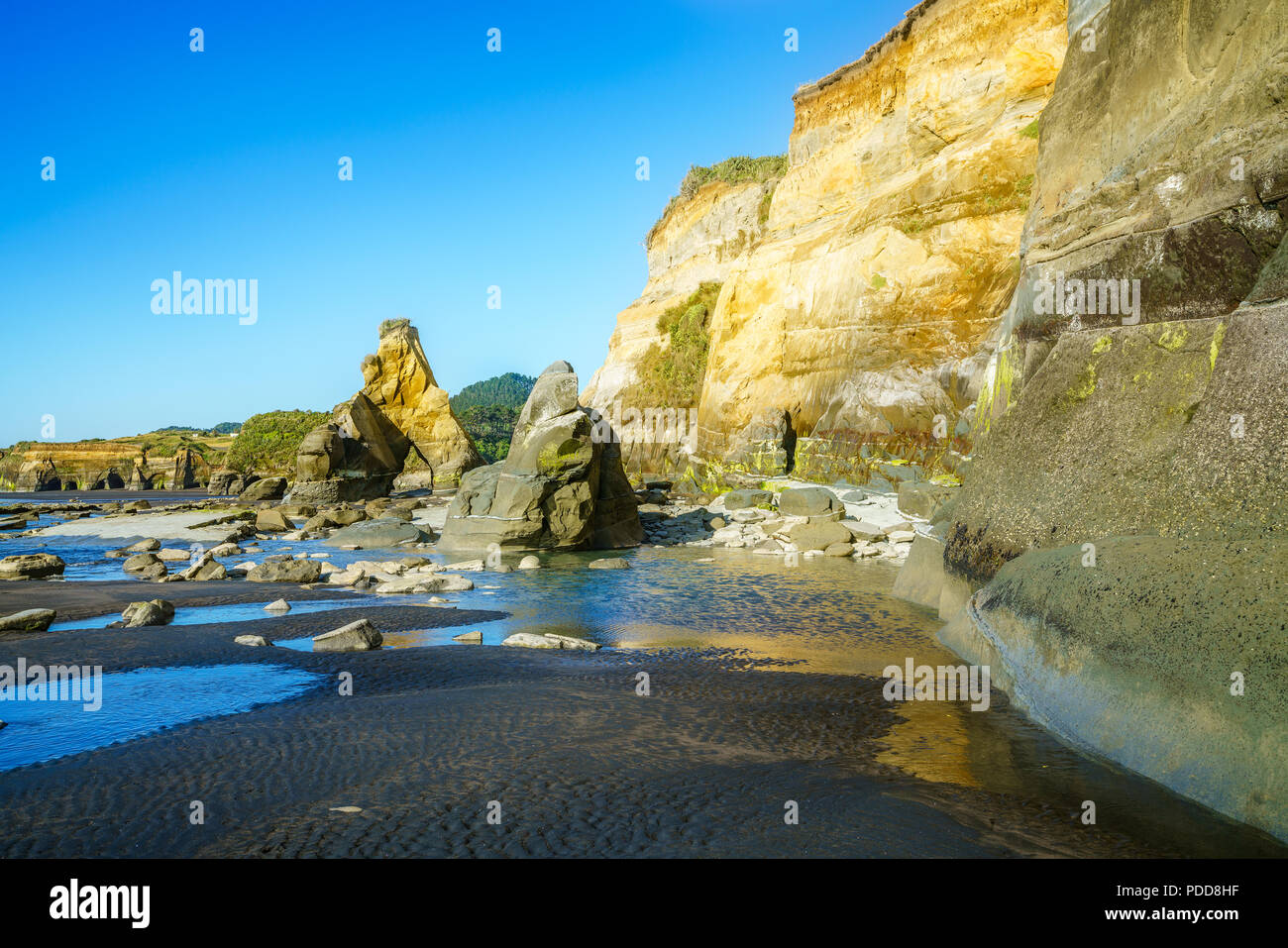 blue water, golden rocks and sand. on the beach, 3 sisters and elephant ...