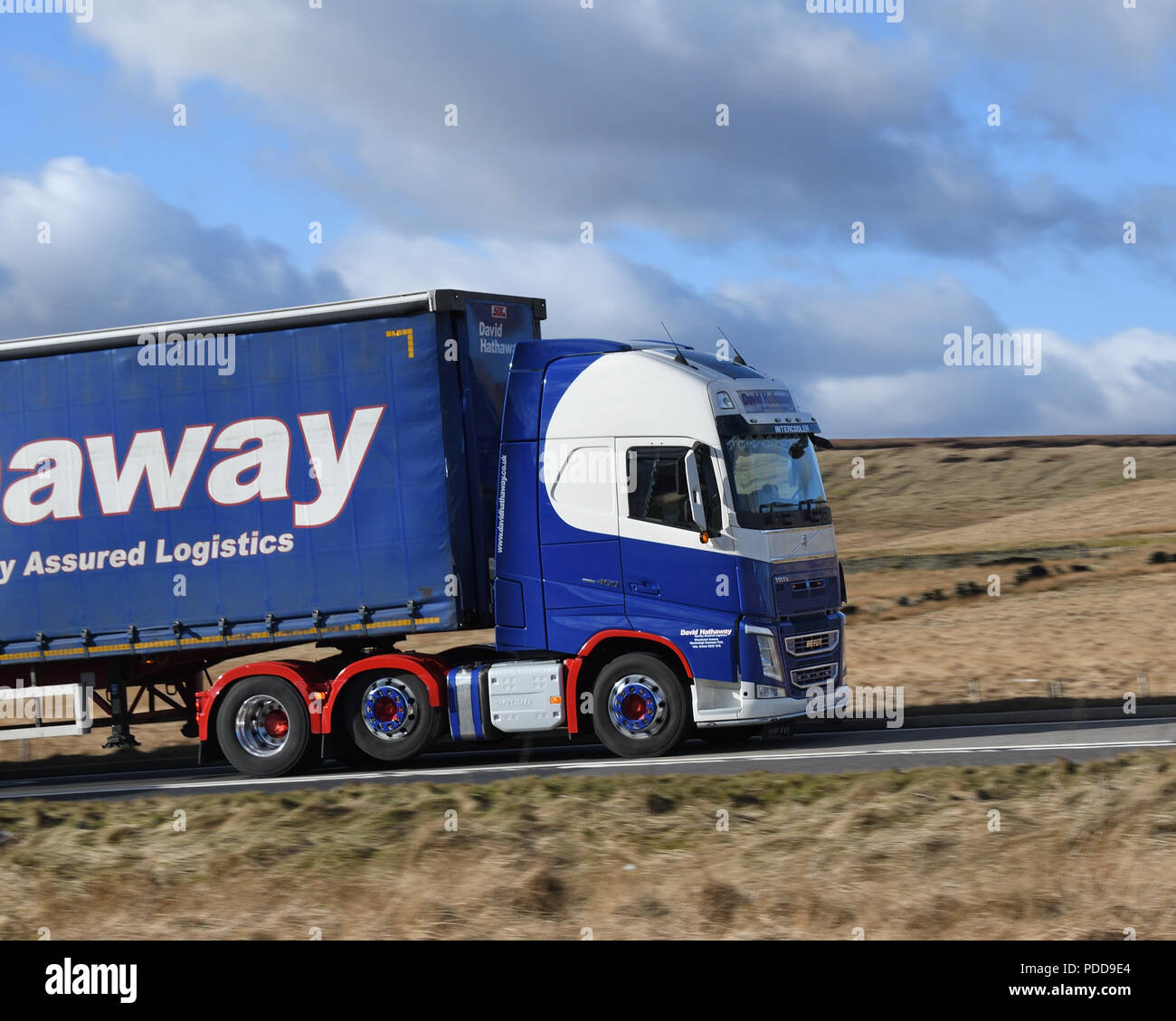 Volvo pulling a curtainsider trailer climbs an incline on the Woodhead ...