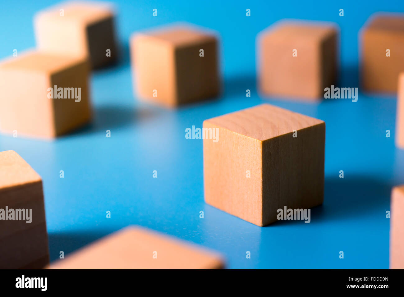Cube wood blocks on blue background Stock Photo - Alamy