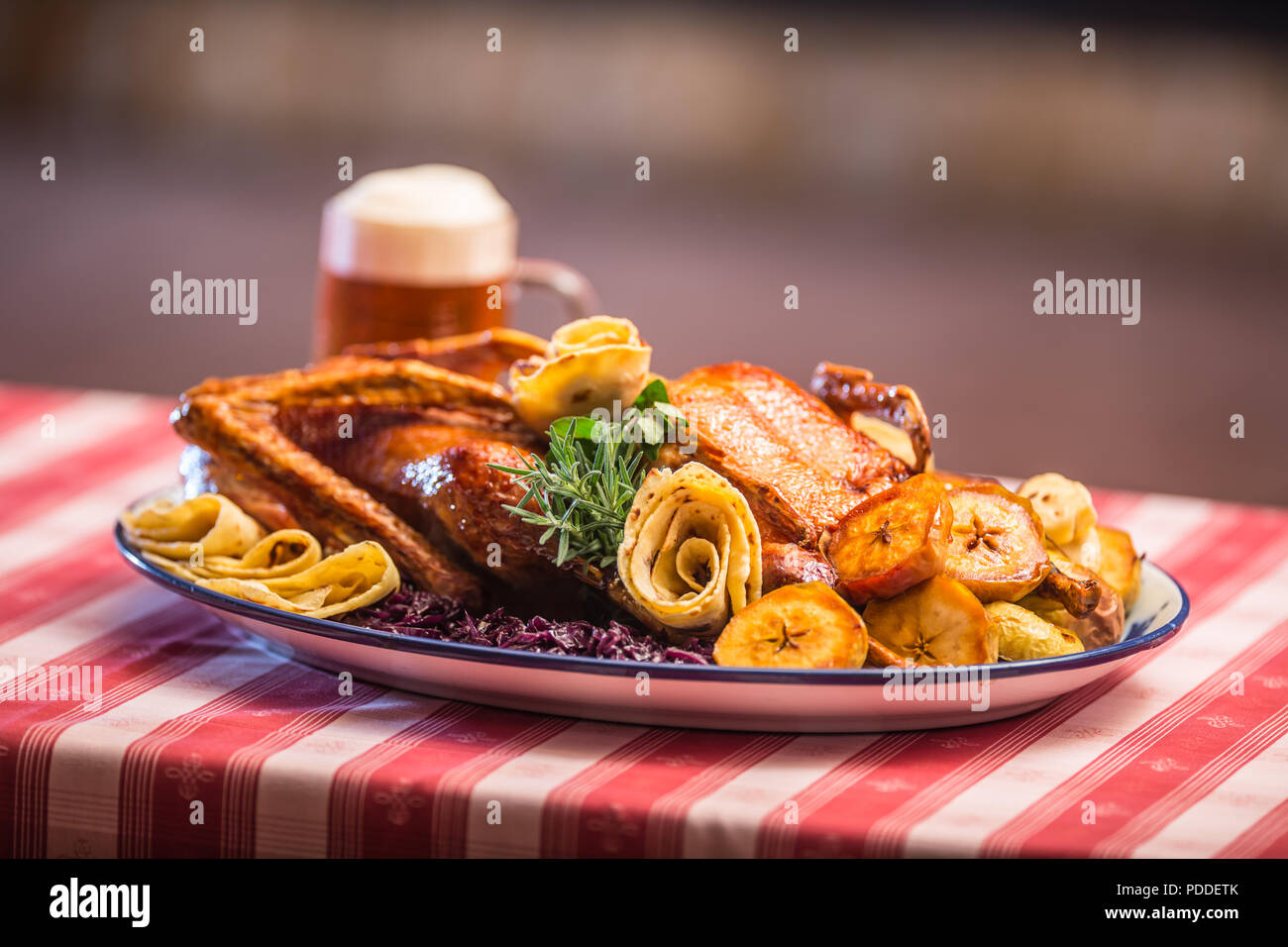 Festive garnished roast duck with apples and red cabbage Stock Photo ...