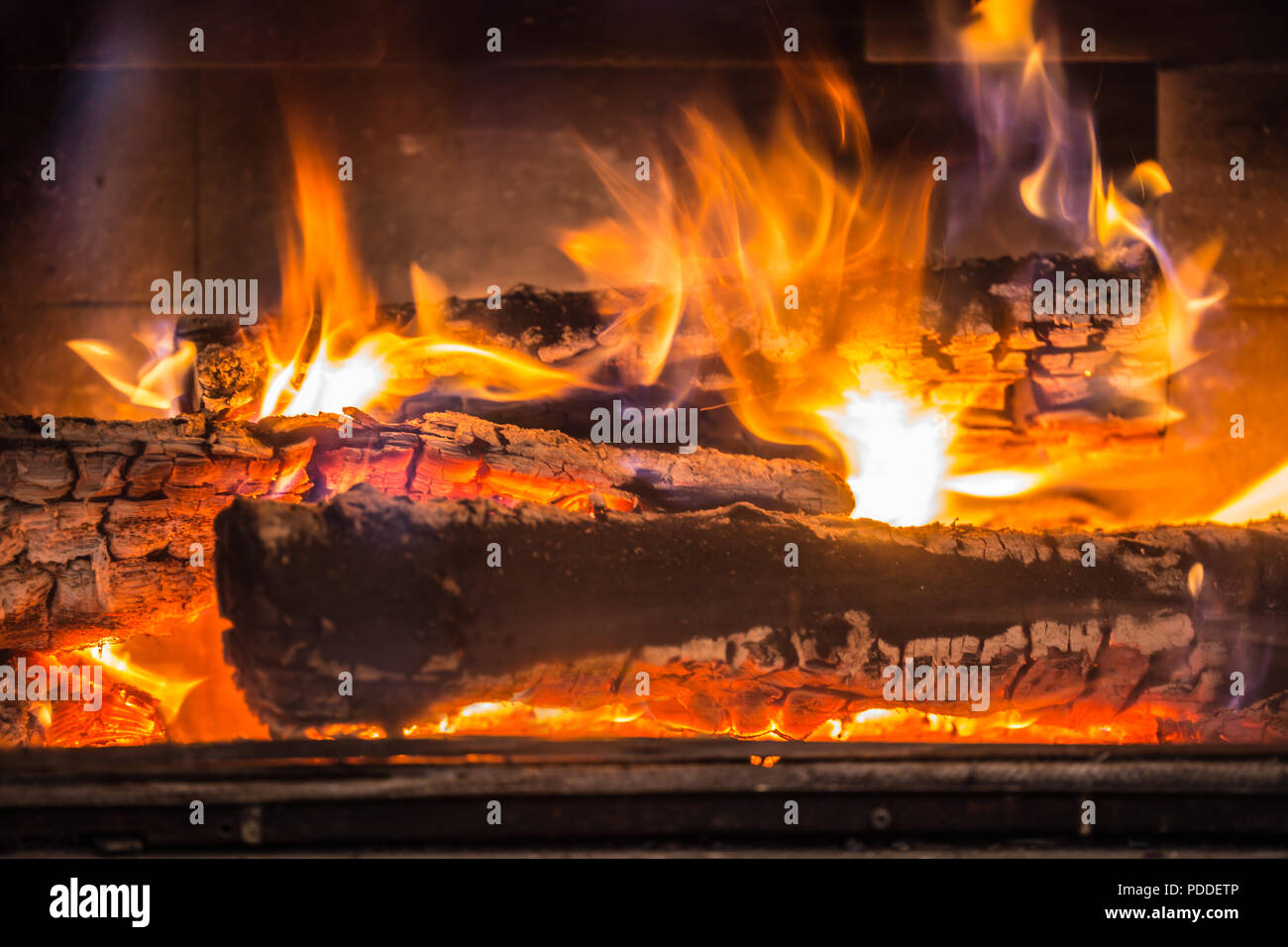 The fireplace with the flaming wood in the home interior Stock Photo ...