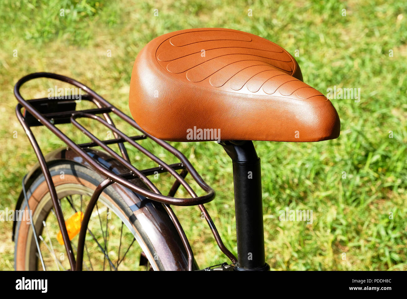 Brown saddle, trunk. Details of the pleasure bike Stock Photo - Alamy