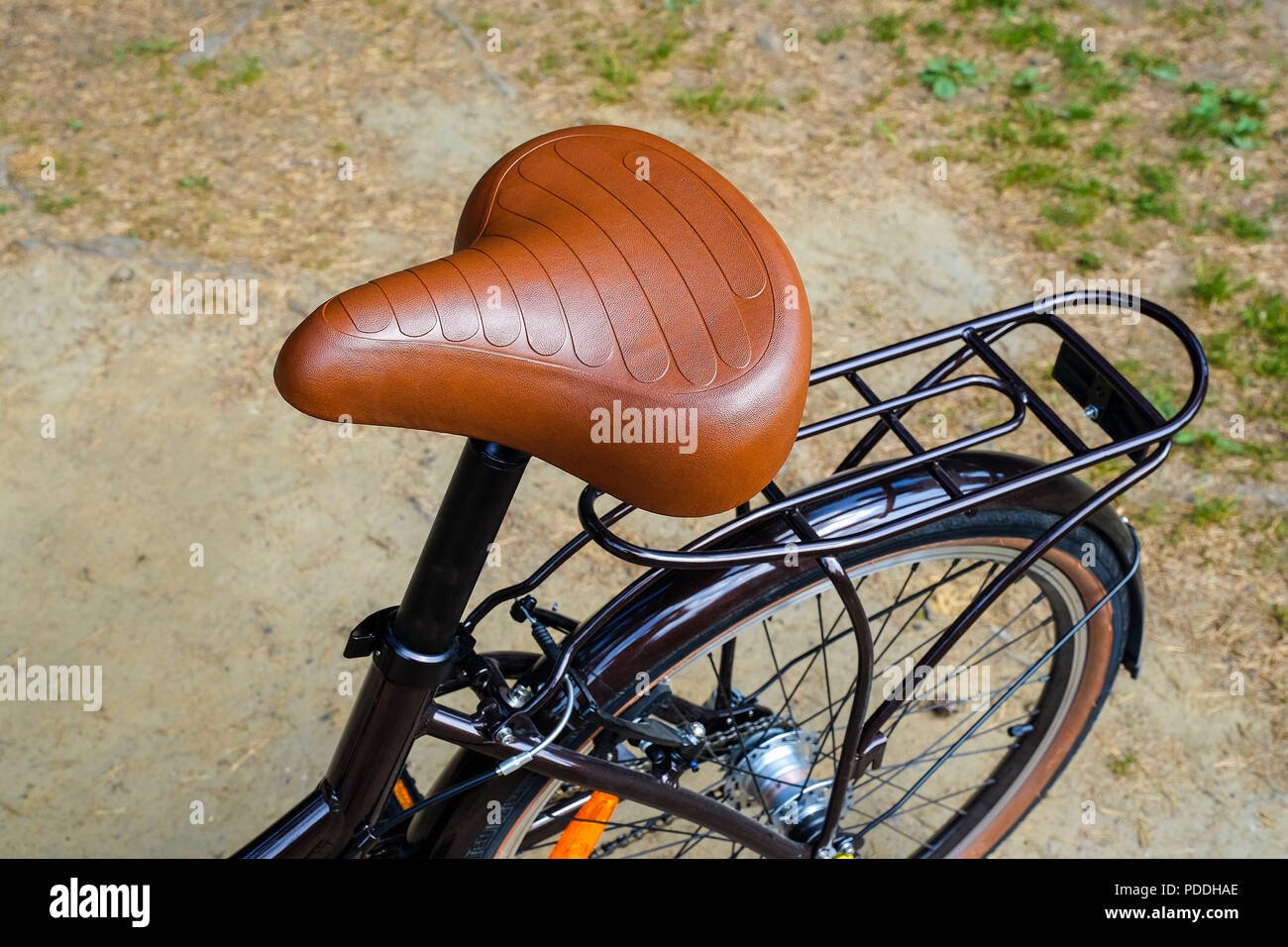 Brown saddle, trunk. Details of the pleasure bike Stock Photo - Alamy