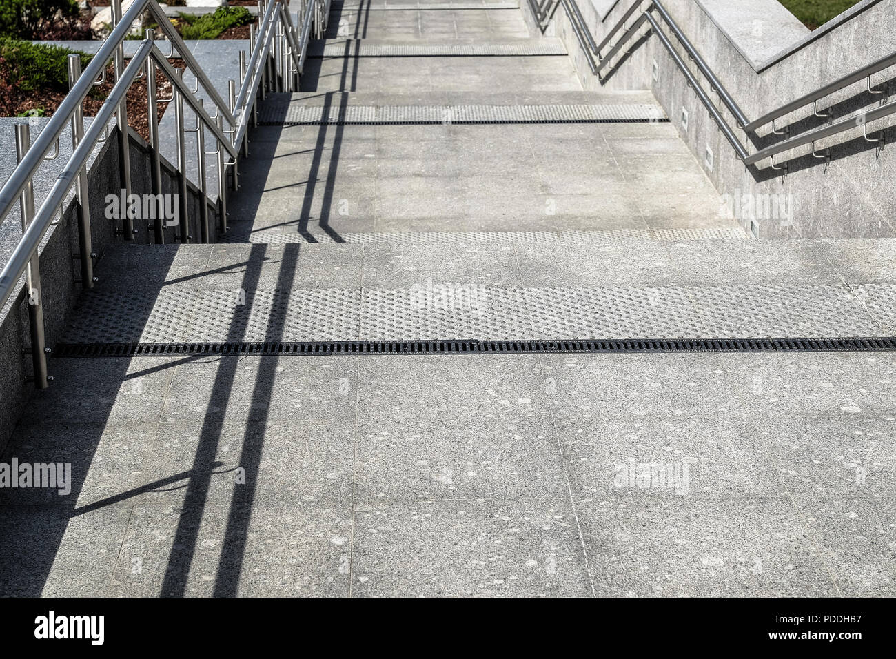 Stairs and steps are decorated with granite and marble tiles with metal ...