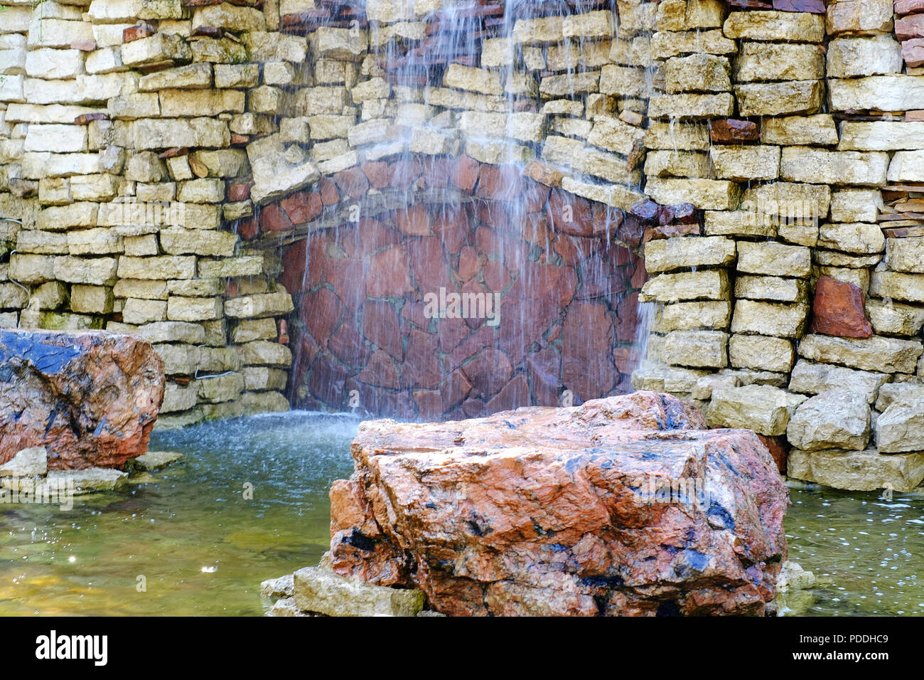 Waterfall in landscape design decorated with natural natural stone ...
