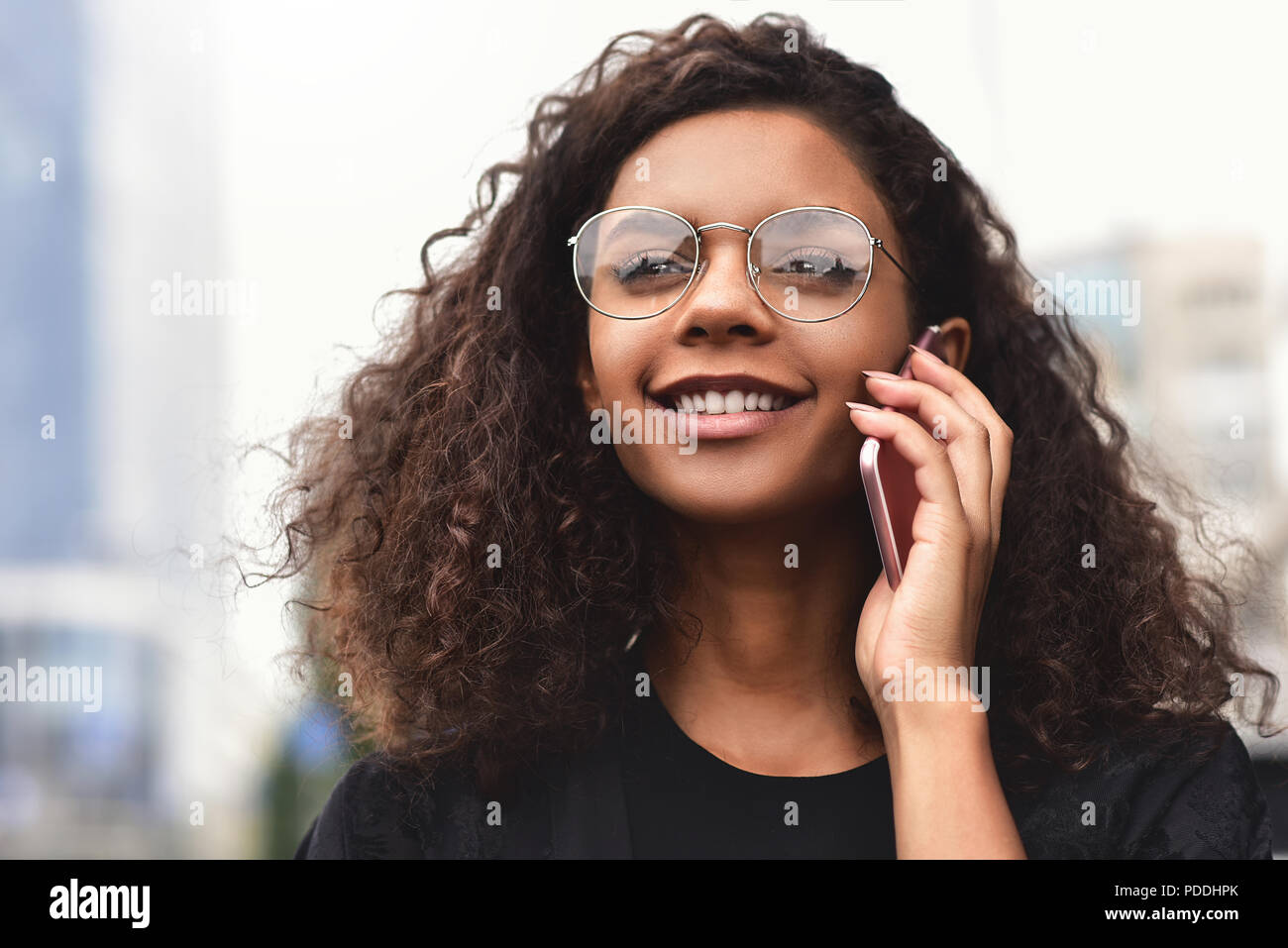 Happy beautiful woman walking and writing or reading sms messages Stock ...