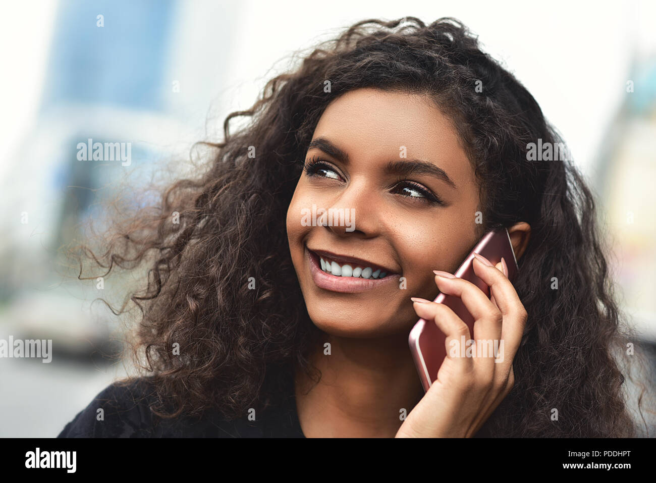 Happy beautiful woman walking and writing or reading sms messages Stock ...