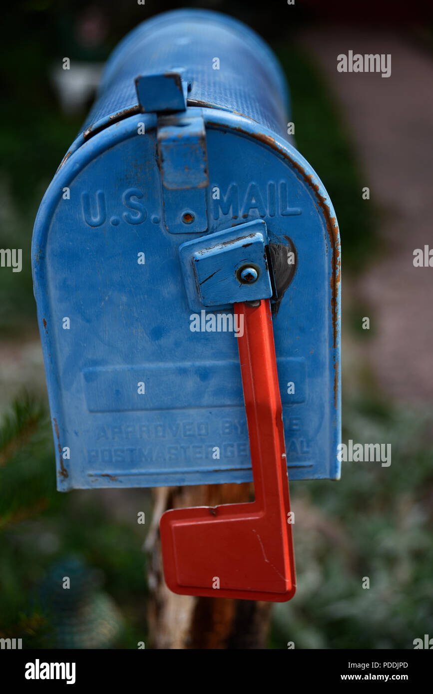 Blue mailbox with a red flag Stock Photo - Alamy