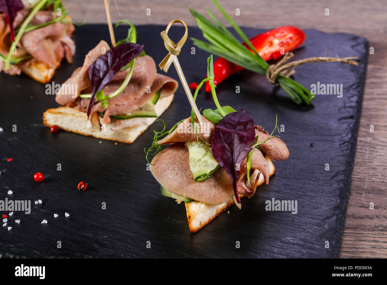 Beef canape served green onion Stock Photo - Alamy